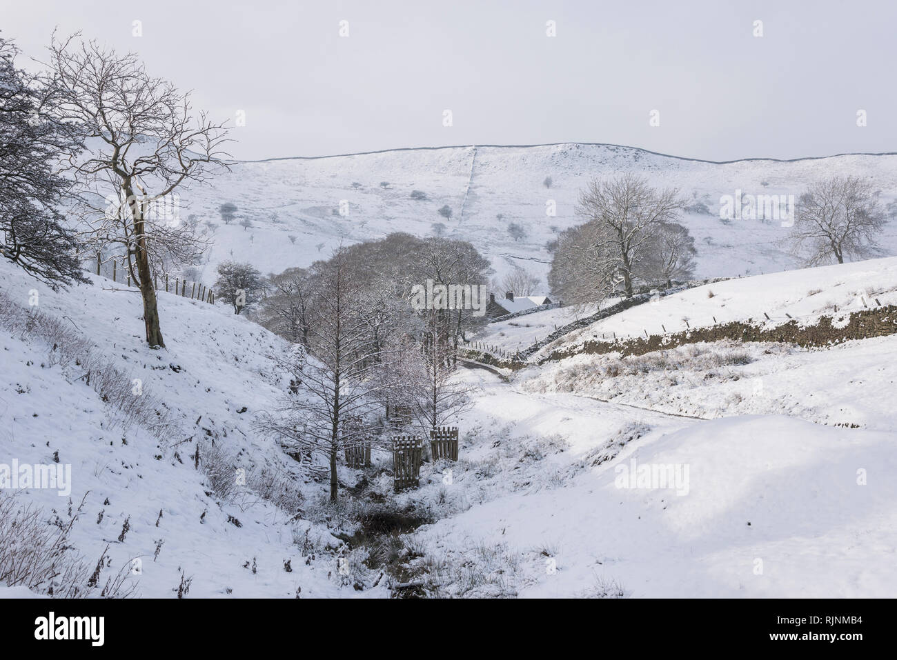 Remote country road in the snowy winter countryside around Hayfield ...
