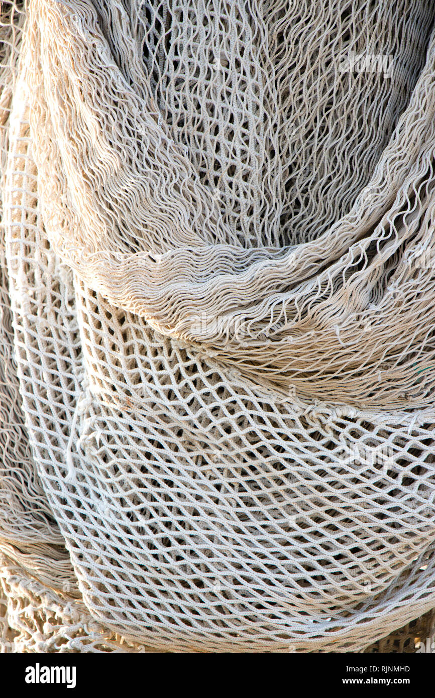 Bunch of fishing trawl net hanging on a trawler boat background Stock ...