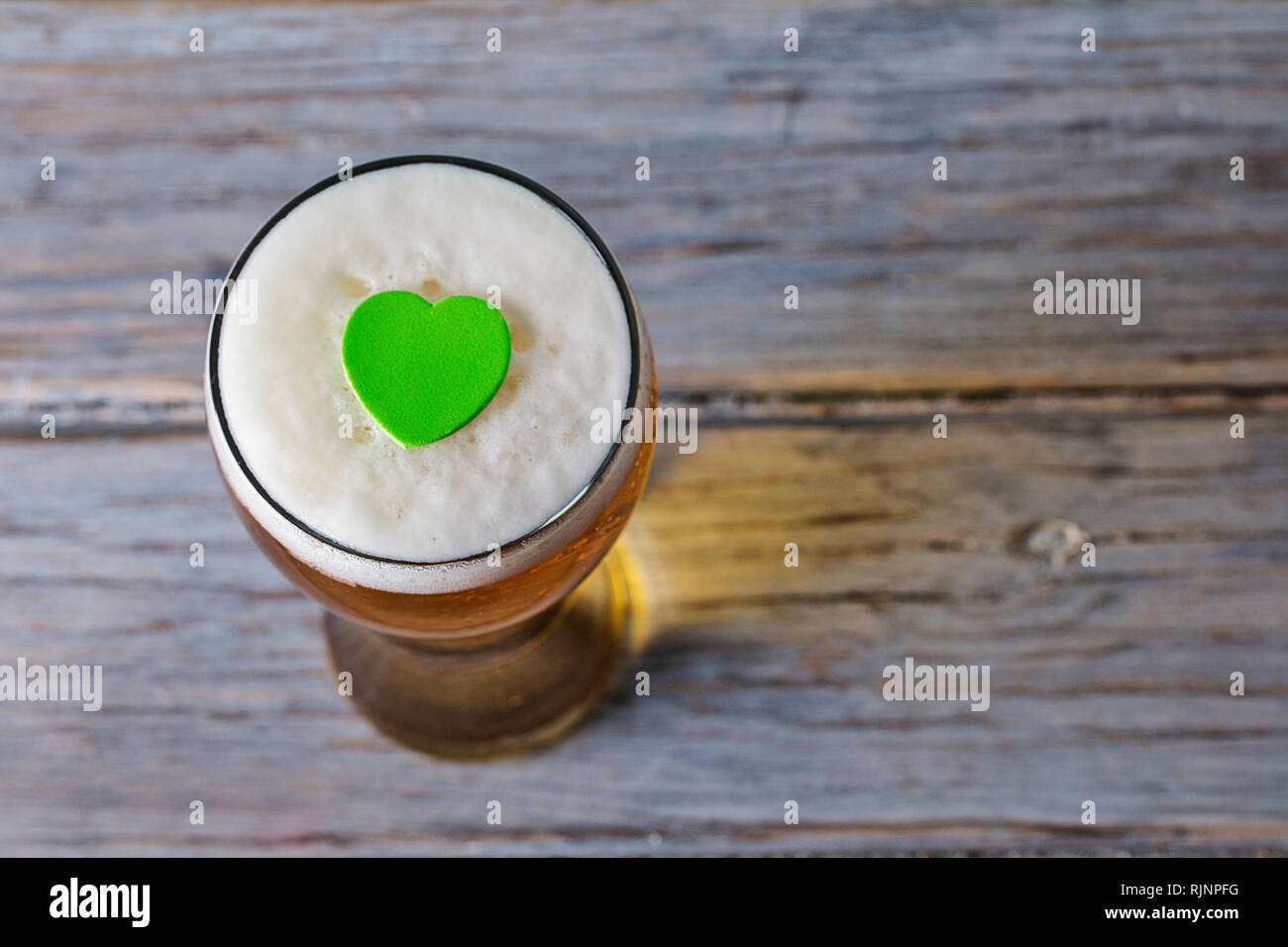 Love beer. Beer glass with green heart Stock Photo - Alamy