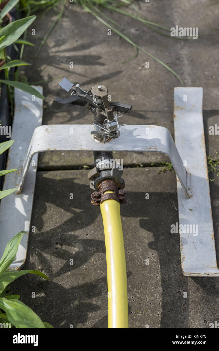 Sprinkler gun in a garden, spring, Pas de Calais, France Stock Photo ...