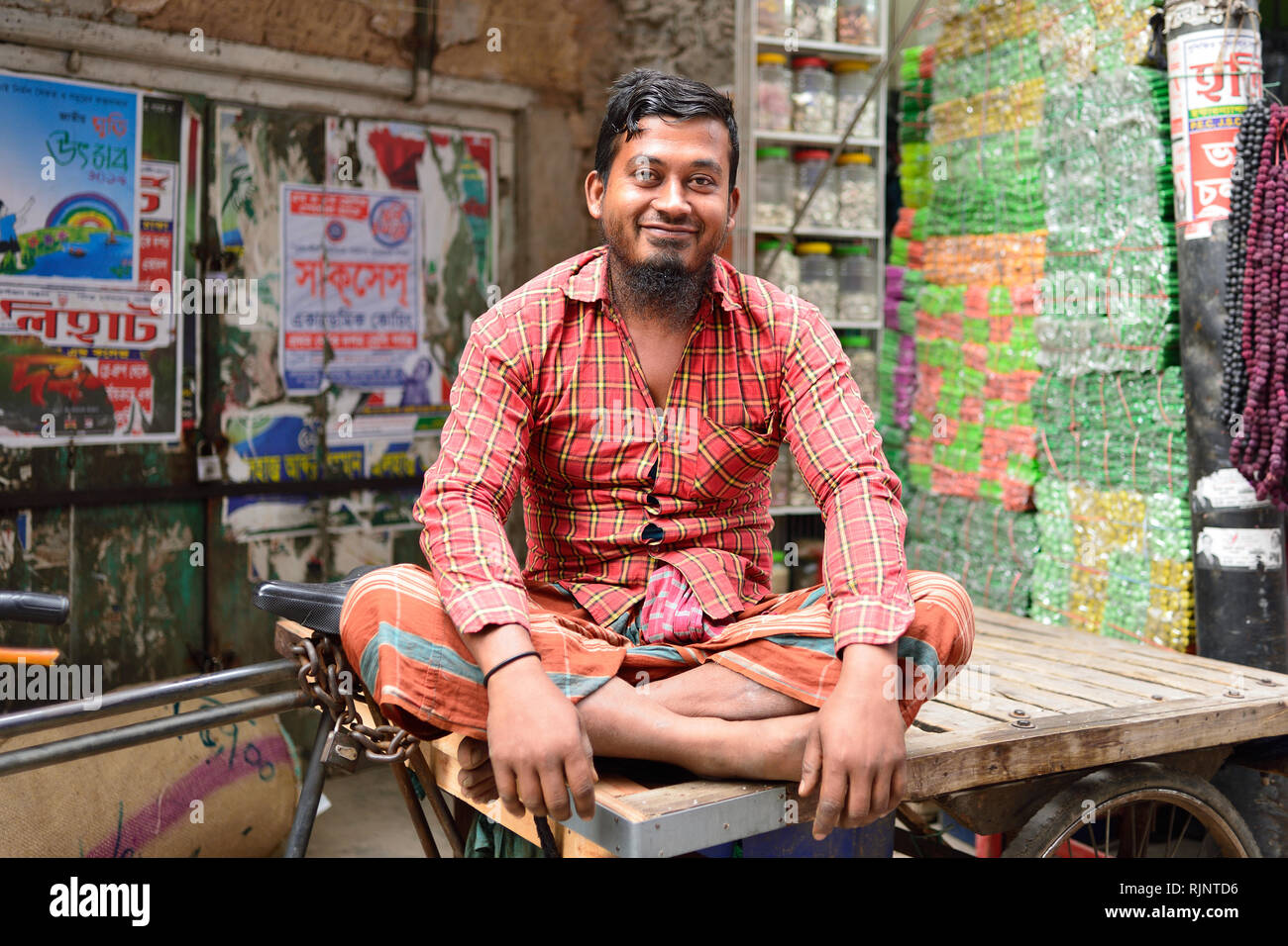 DHAKA, BENGAL BANGLADESH - 28 JANUARY 2019: Rickshaw driver on streets ...
