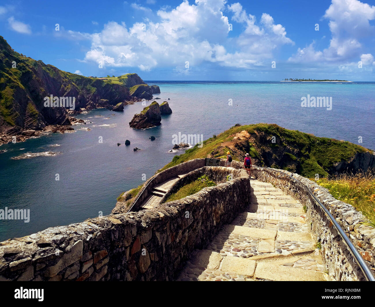 Group of tourists descending beautiful path of gaztelugatxe in Basque ...