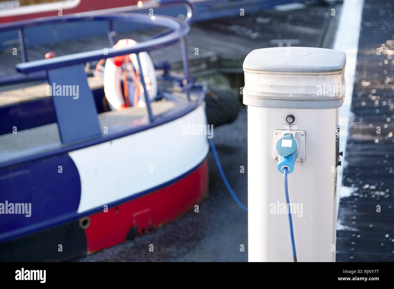 Electric charging point for boat and barge at marina mooring on canal ...