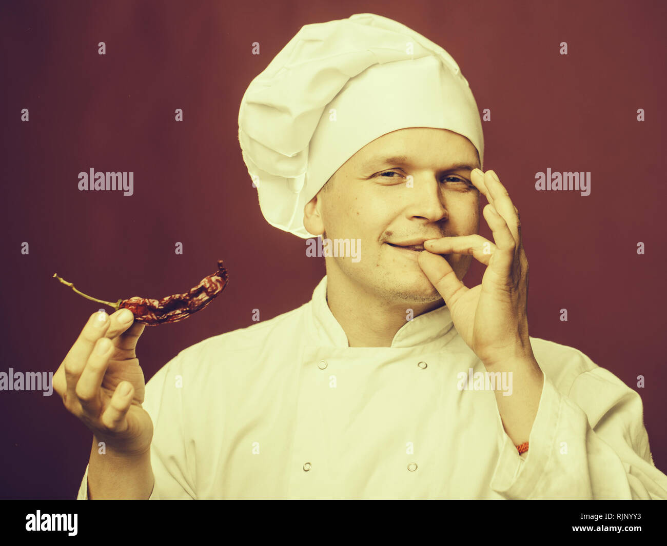 Chef with chili pepper Stock Photo - Alamy