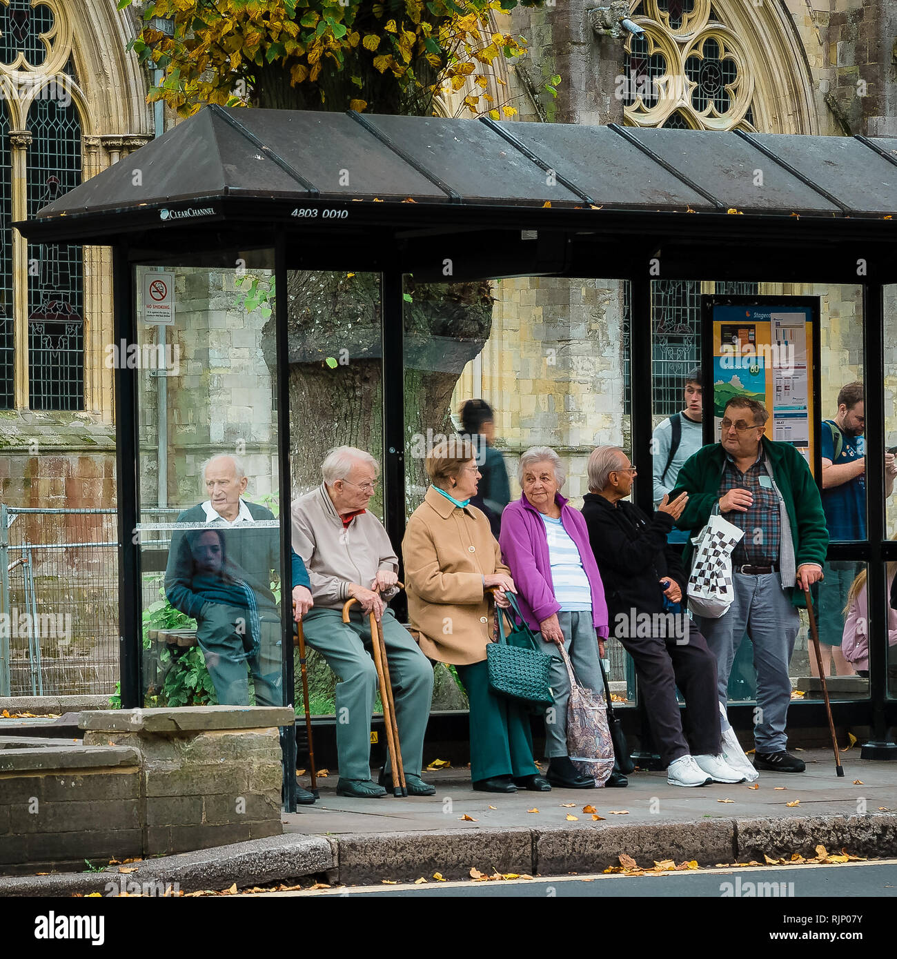 Couple conversing waiting bus stop hi-res stock photography and images ...