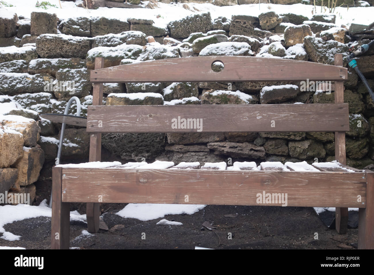 On the tables and benches of the street cafe lies cold snow. WInter ...