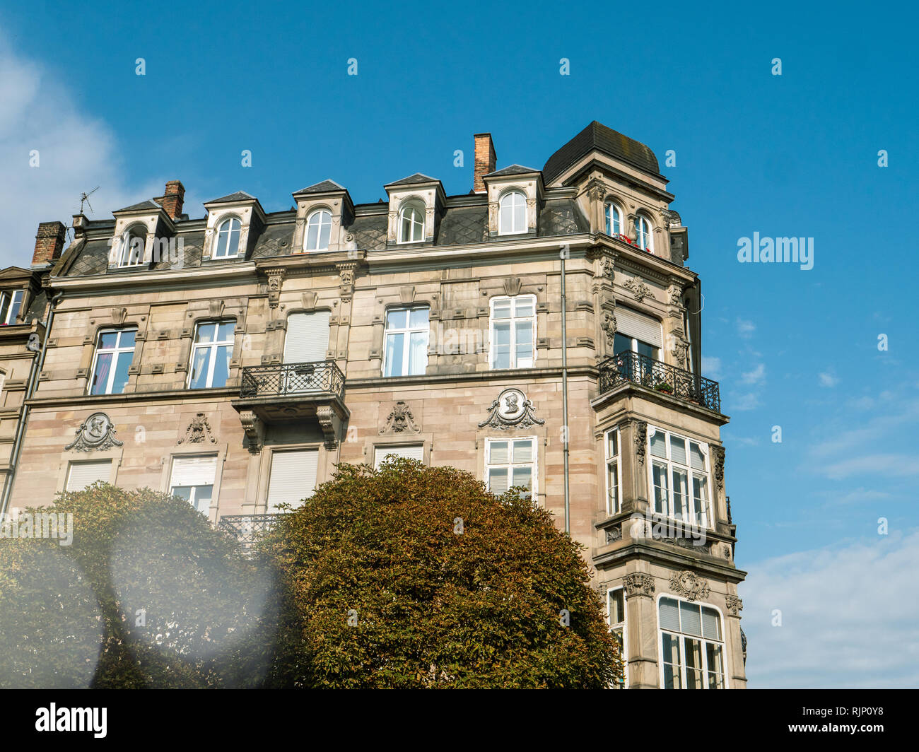 POV from below shot of beautiful building exterior with balconies and ...