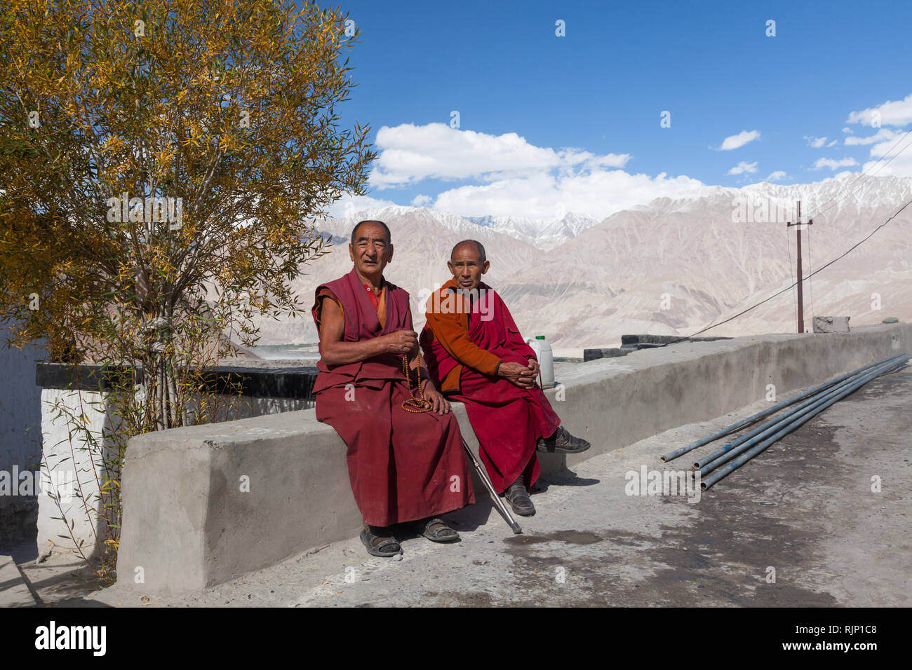 Two monks in Diskit Gompa (also known as Deskit Gompa), Nubra Valley ...