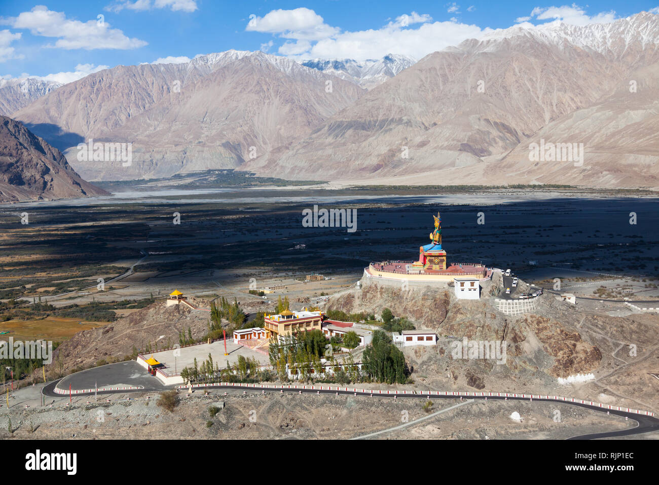 Landscape with statue of Jampa (Maitreya) Buddha seen from Diskit Gompa ...