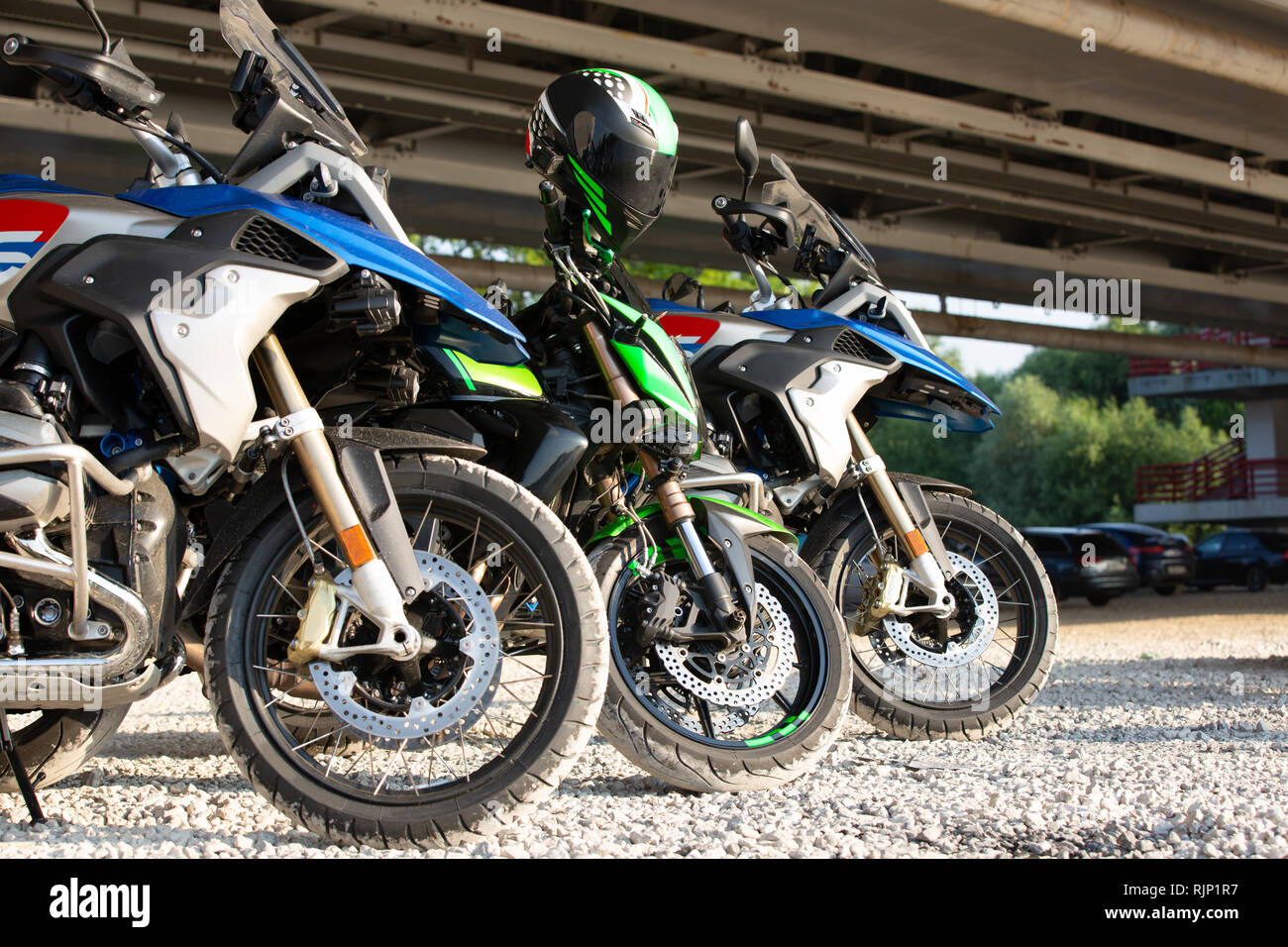 Row of three motorcycle wheels parked in a road Stock Photo - Alamy