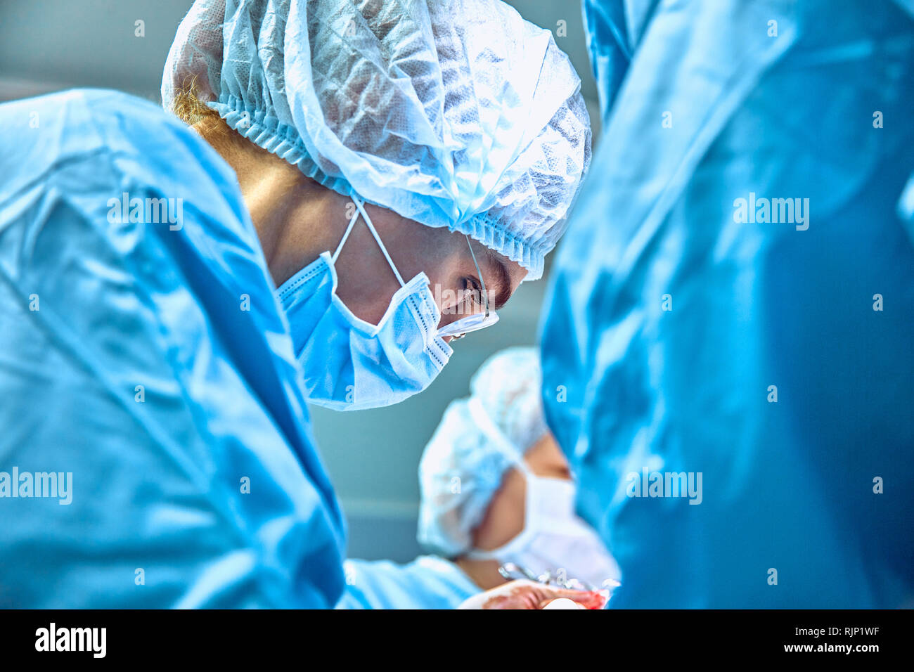 Close up portrait of young female surgeon doctor wearing protective ...