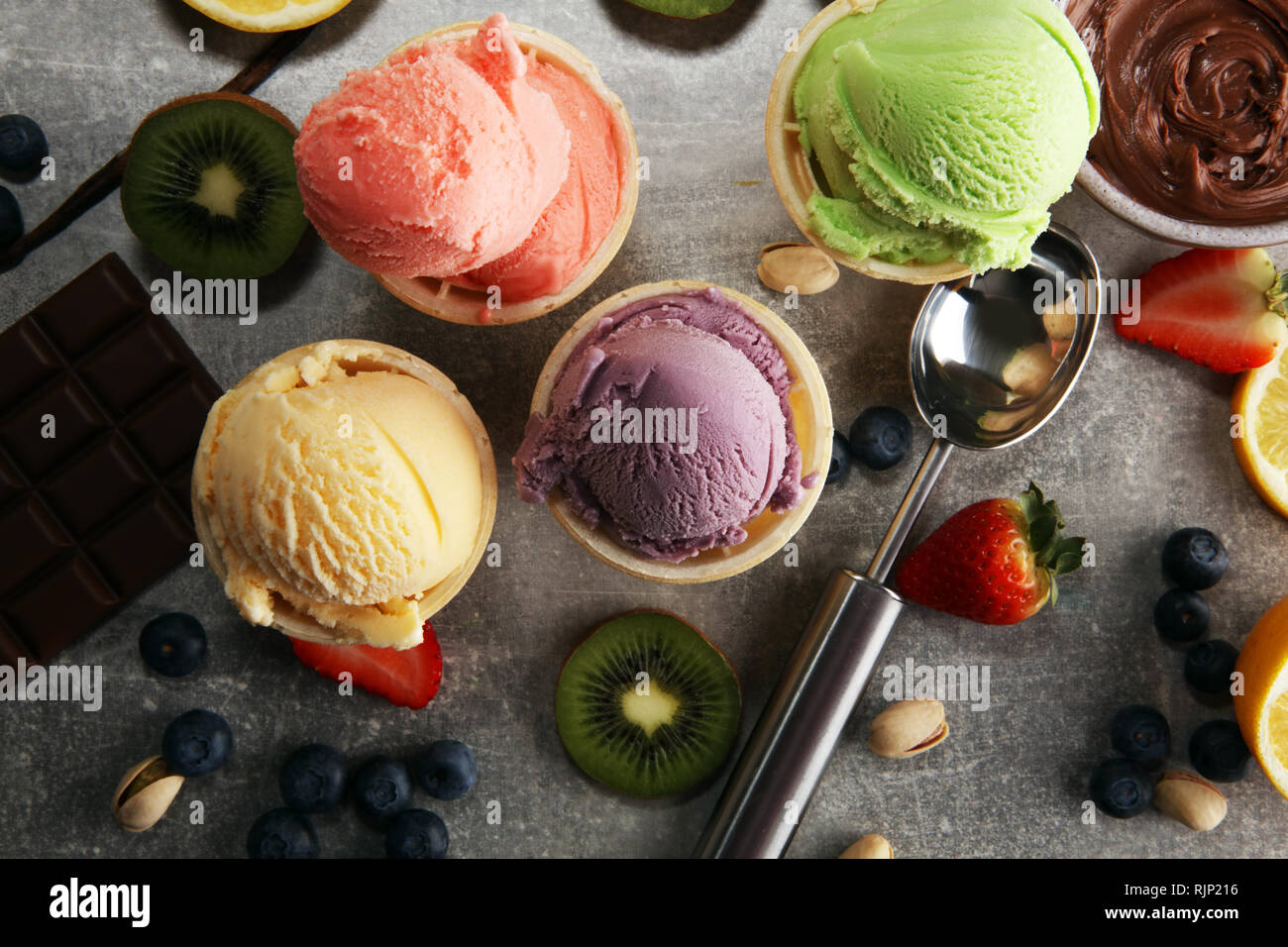 Set of ice cream scoops of different colors and flavours with berries ...