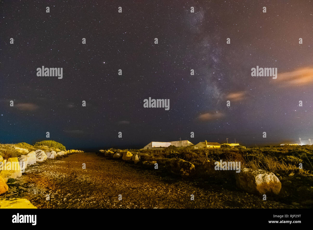milky way with an isolated path in the nature and house Stock Photo - Alamy