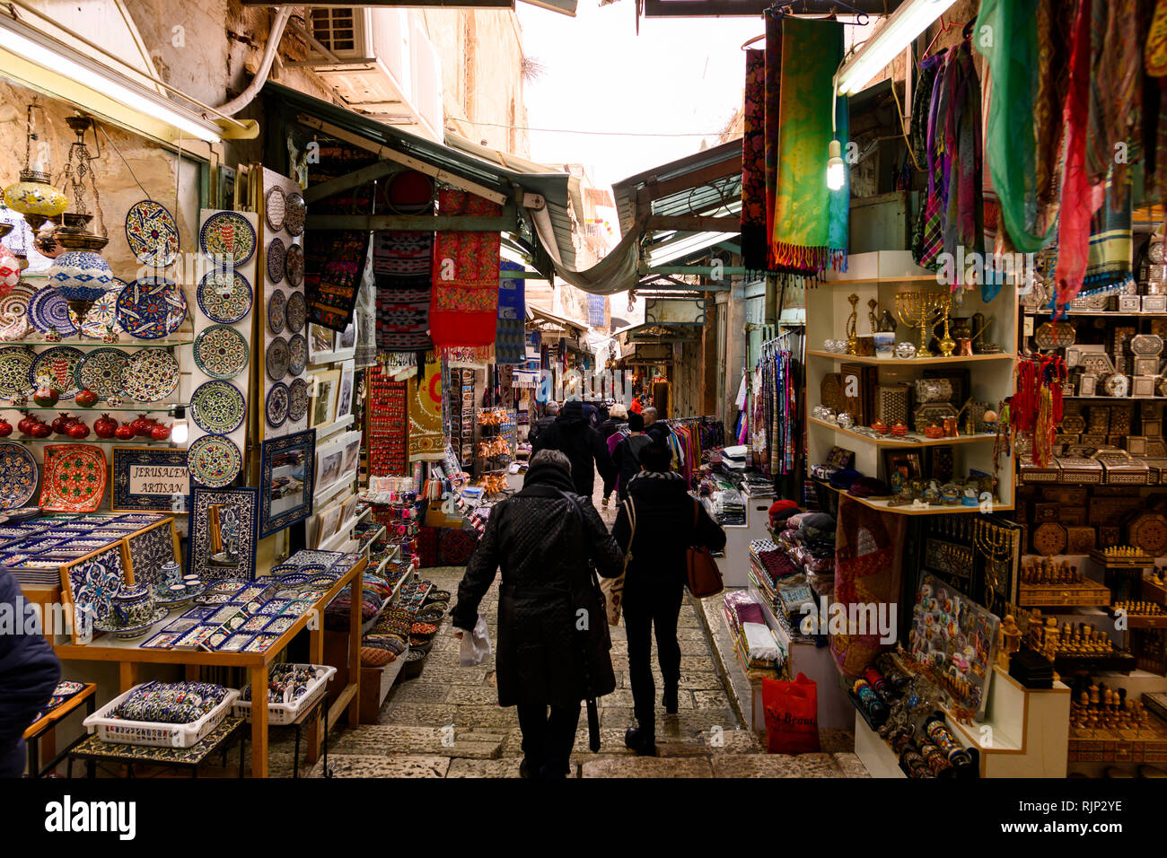 Some people walk through the streets of the old city of Jerusalem with ...
