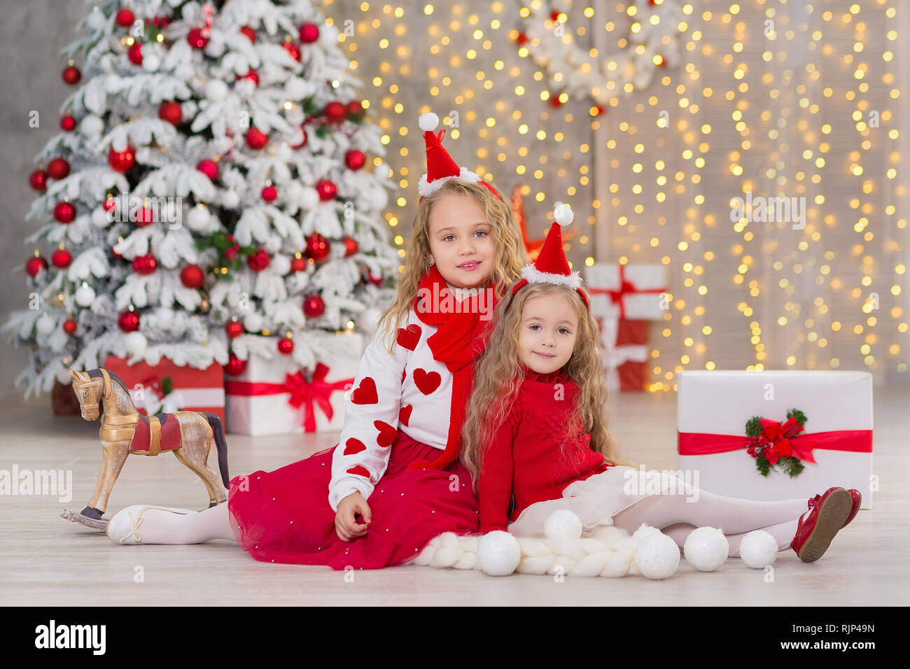 Christmas portrait of two beautyful cute girls Smiling sisters friends ...