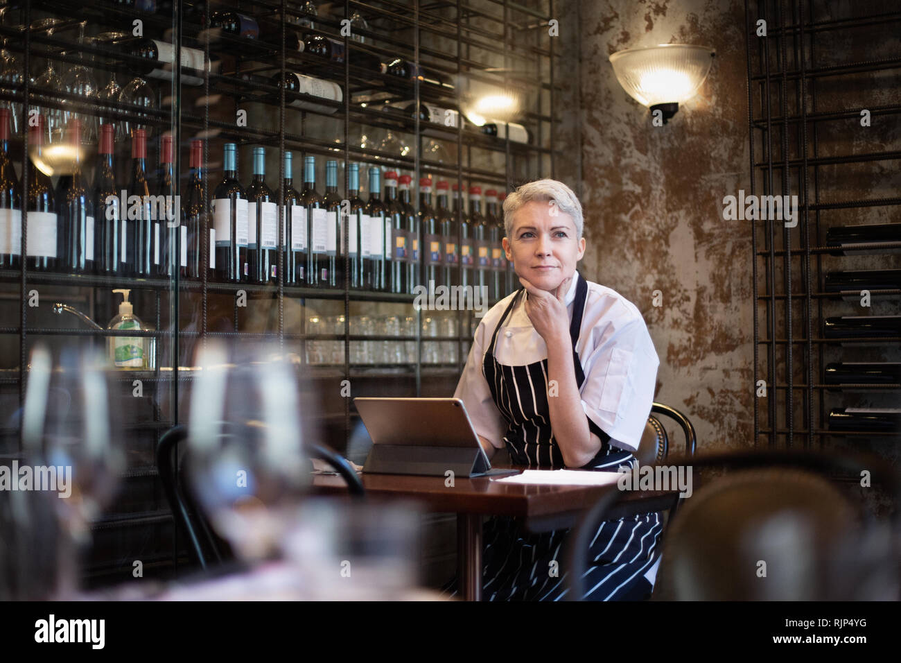 Female restaurant owner thinking about expansion Stock Photo - Alamy