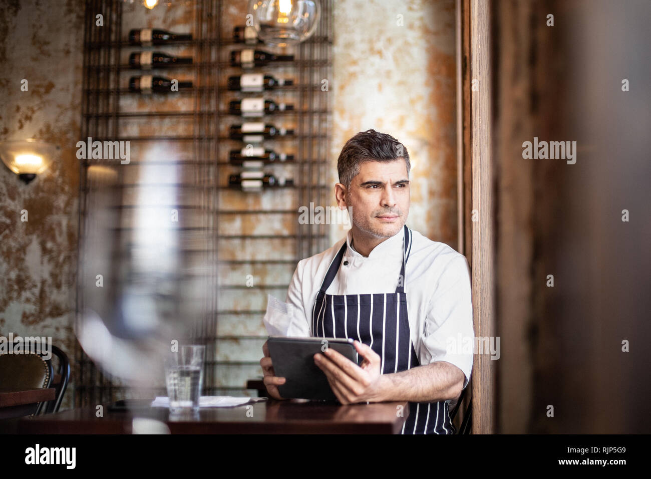 Male restaurant owner thinking about expansion Stock Photo - Alamy