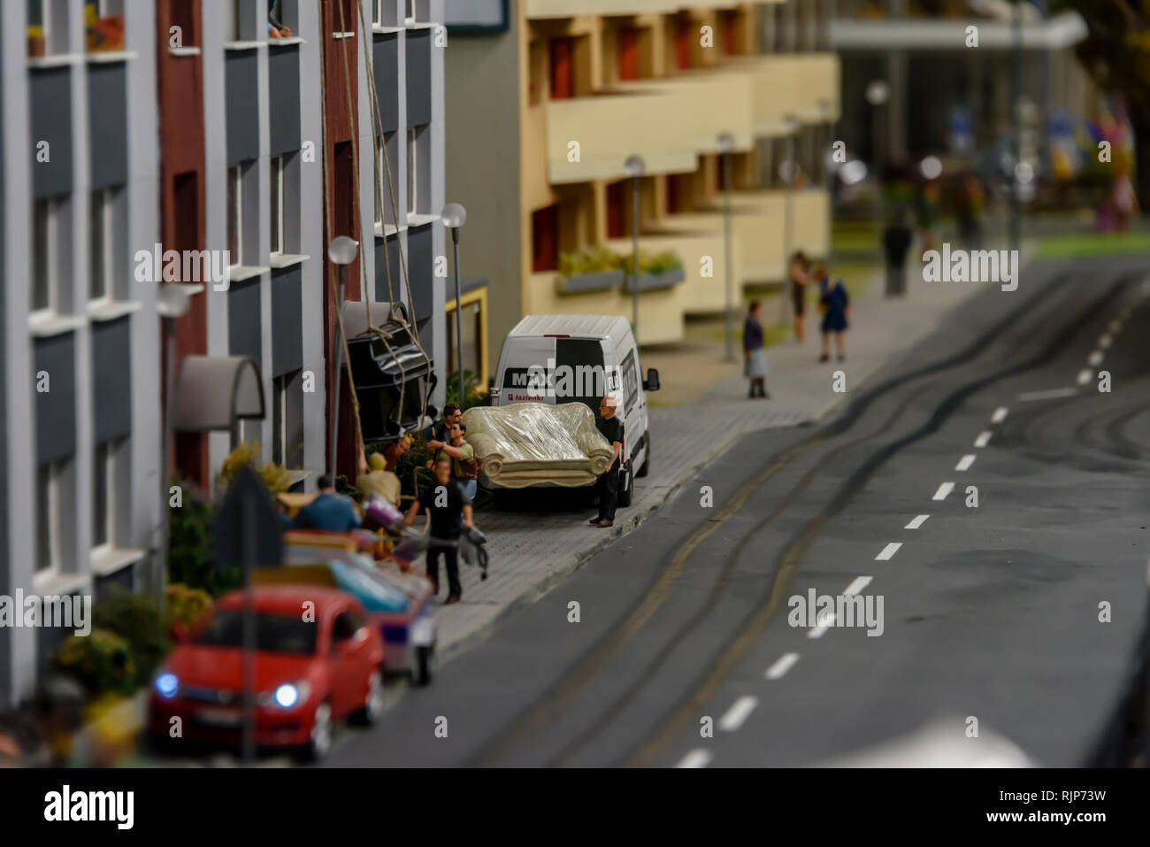 Miniature model of people pulling a piano up a tall building, at ...