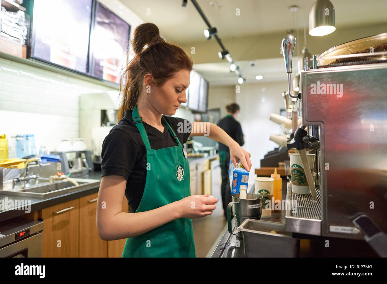 SAINT PETERSBURG, RUSSIA - MARCH 12, 2016: worker at Starbucks Cafe ...