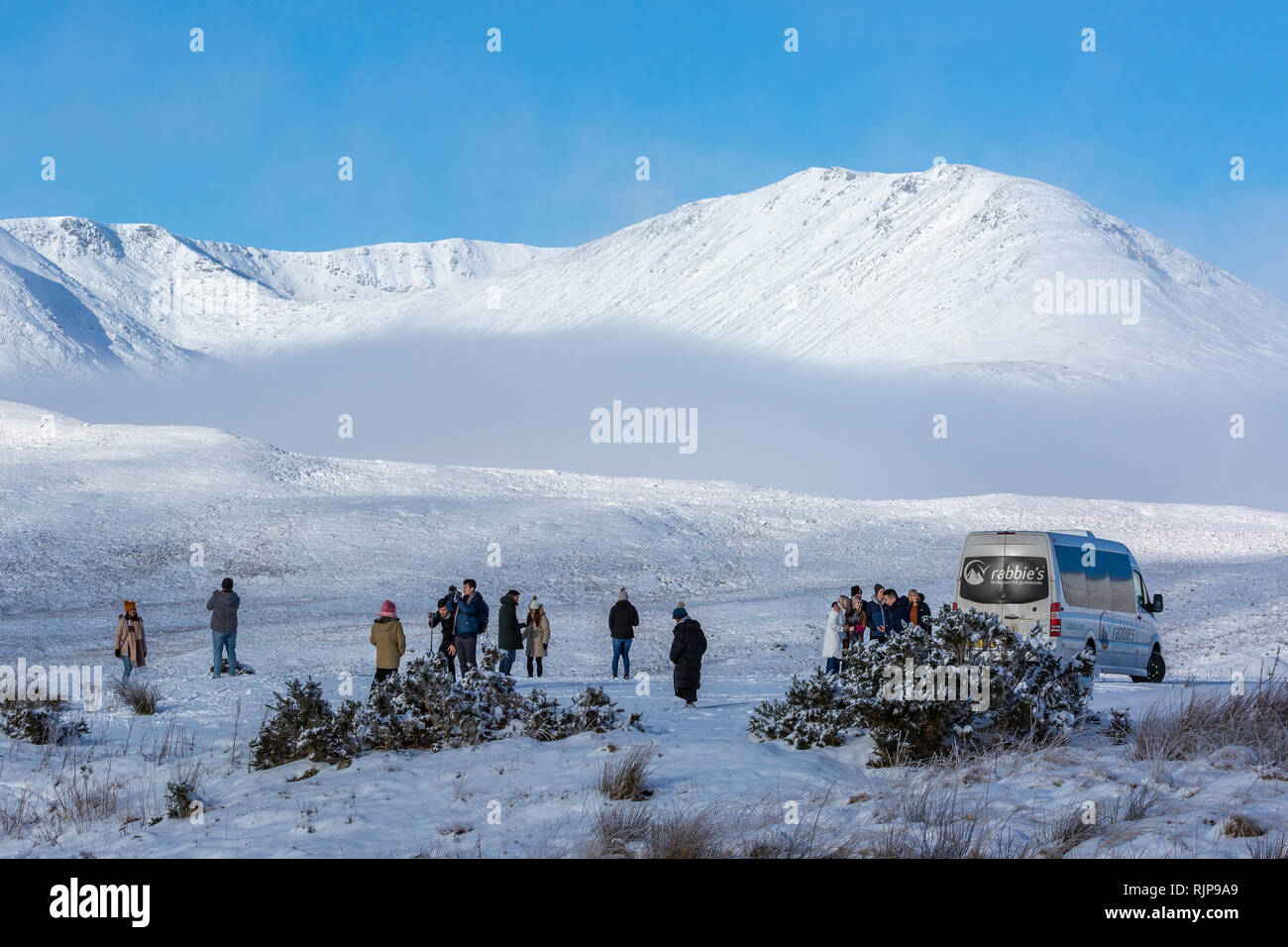 Visitors, tourists, people enjoying the winter scenery on a minibus ...