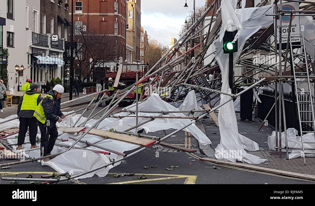 Workmen tidy fallen scaffolding at the junction of Pont Street and ...