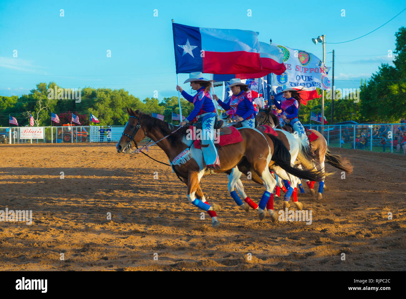 Lone Star Cowgirls entertaining a Texas Pro Rodeo Crowd Stock Photo - Alamy
