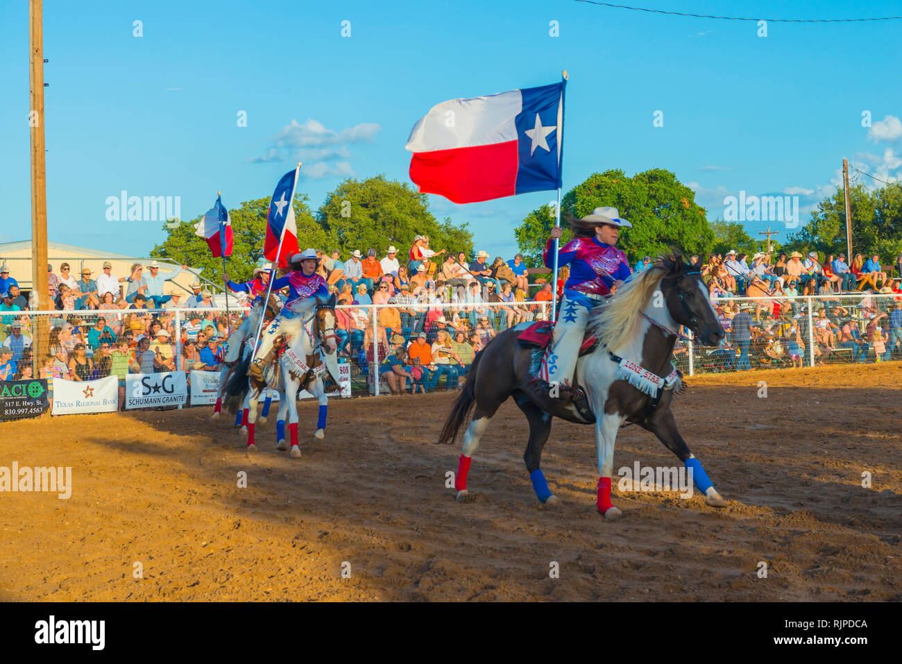 Lone Star Cowgirls entertaining a Texas Pro Rodeo Crowd Stock Photo - Alamy