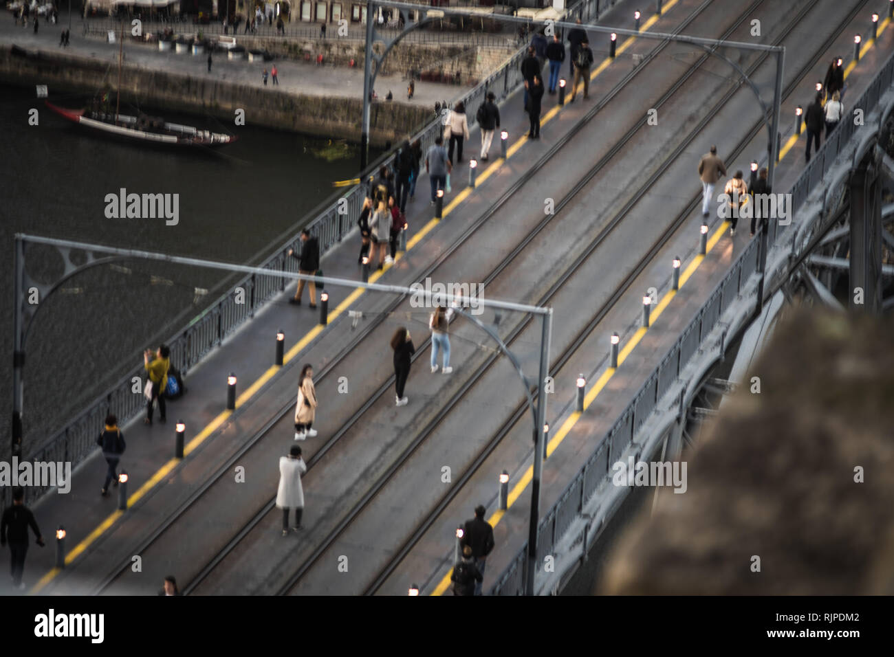 people walk over the dom luis bridge in the city of porto, Portugal ...