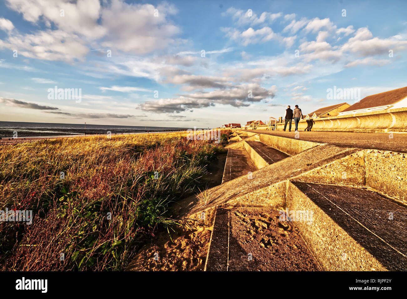 People strolling along Hunstanton prom at sunset. Hunstanton faces west ...