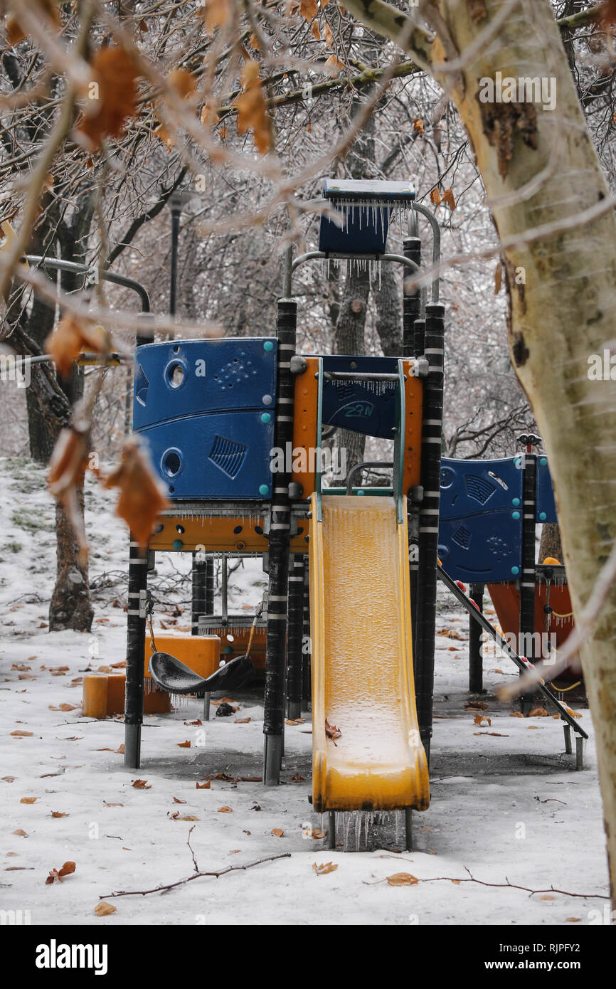 Frozen children playground after a freezing rain weather phenomenon ...