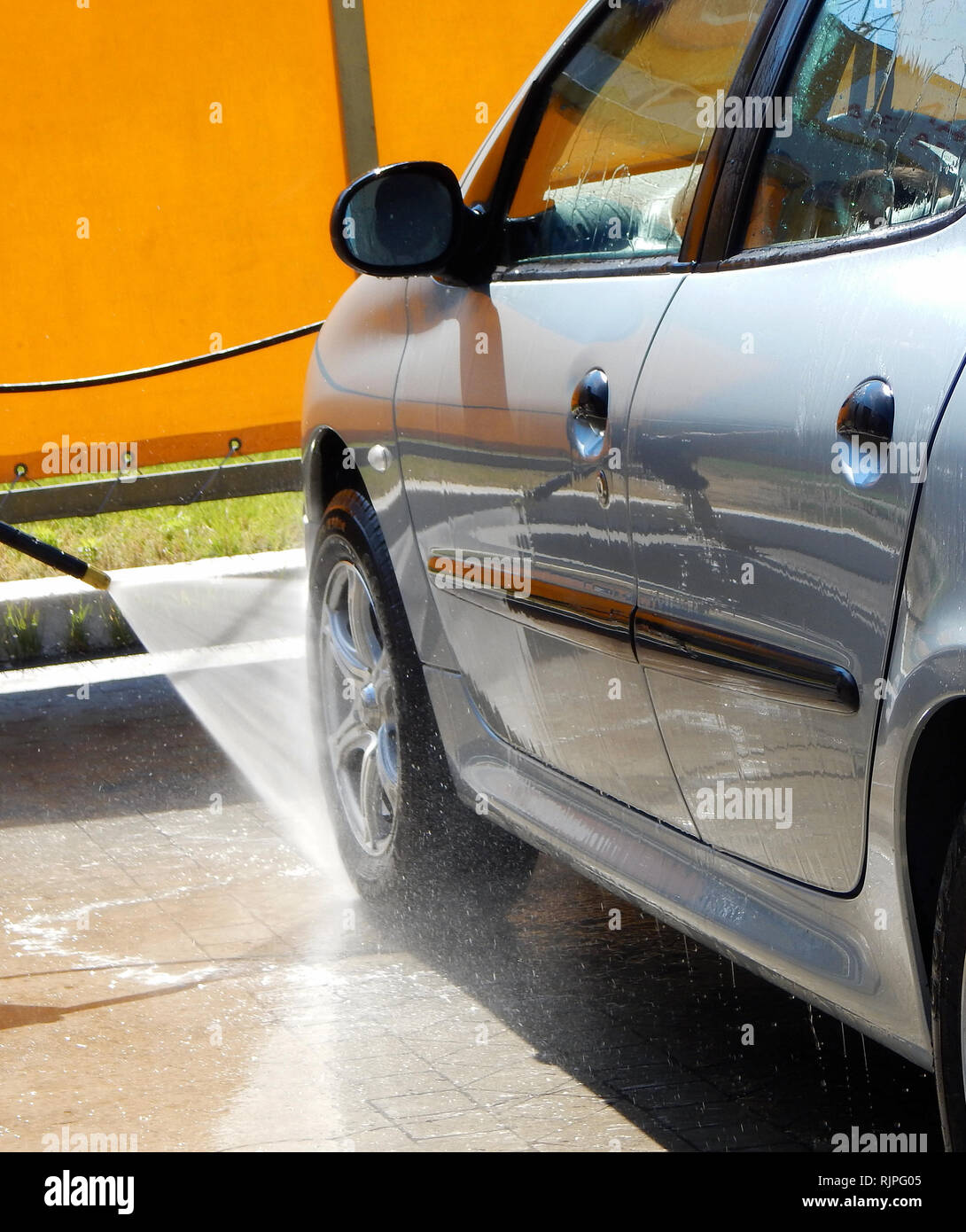 Jet Washer Machine Washing Front Wheel Of Vehicle Stock Photo - Alamy