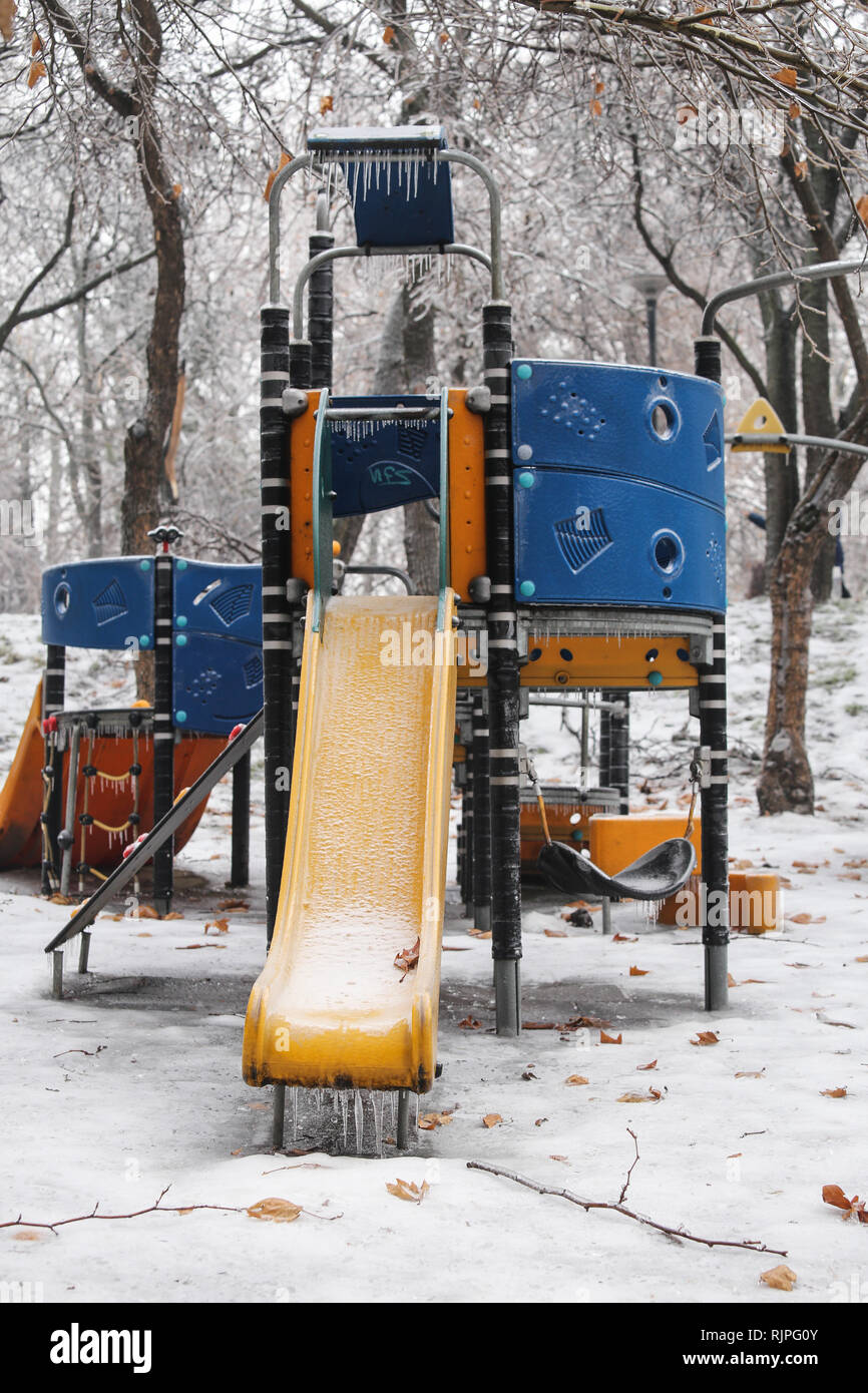 Frozen children playground after a freezing rain weather phenomenon ...
