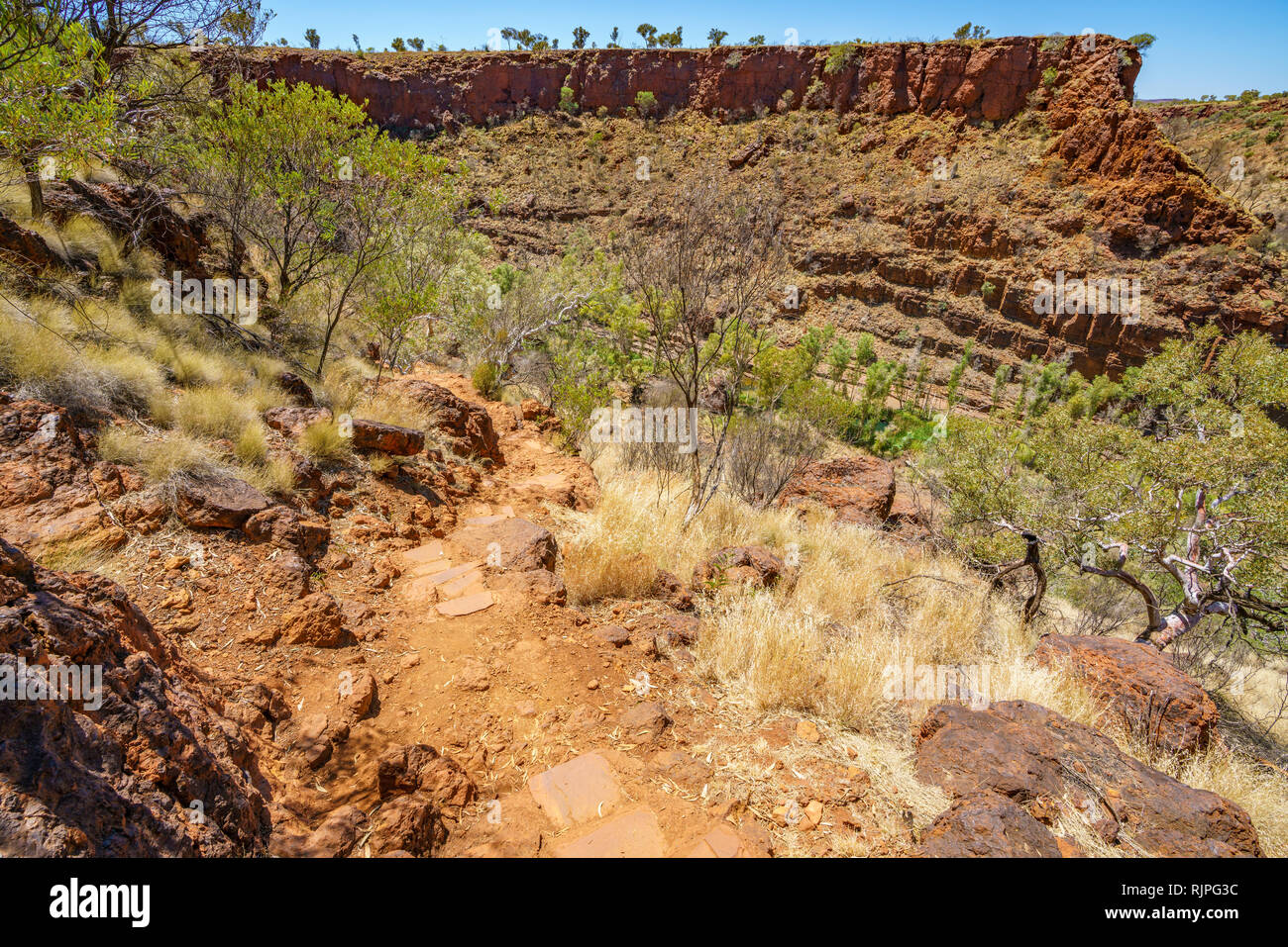 hiking over rocks in dales gorge, karijini national park, western ...