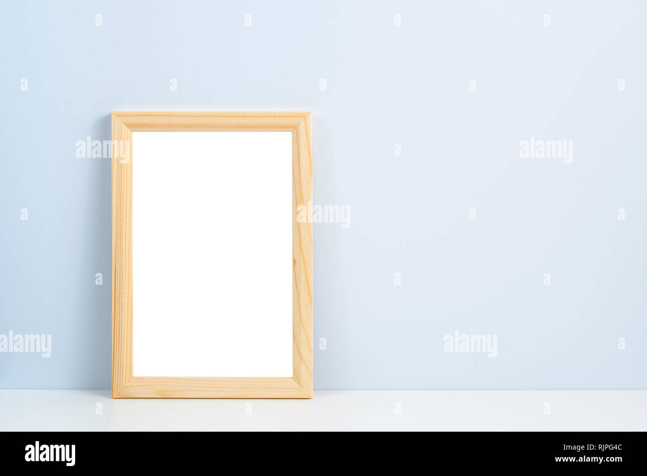 Wooden photo frame standing on shelf Stock Photo - Alamy