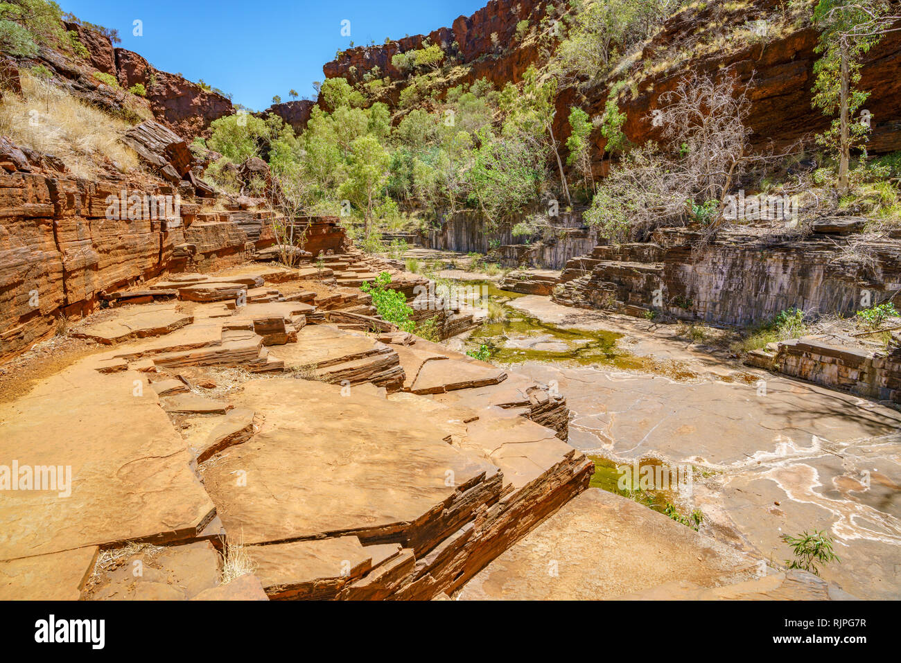 hiking over rocks in dales gorge, karijini national park, western ...