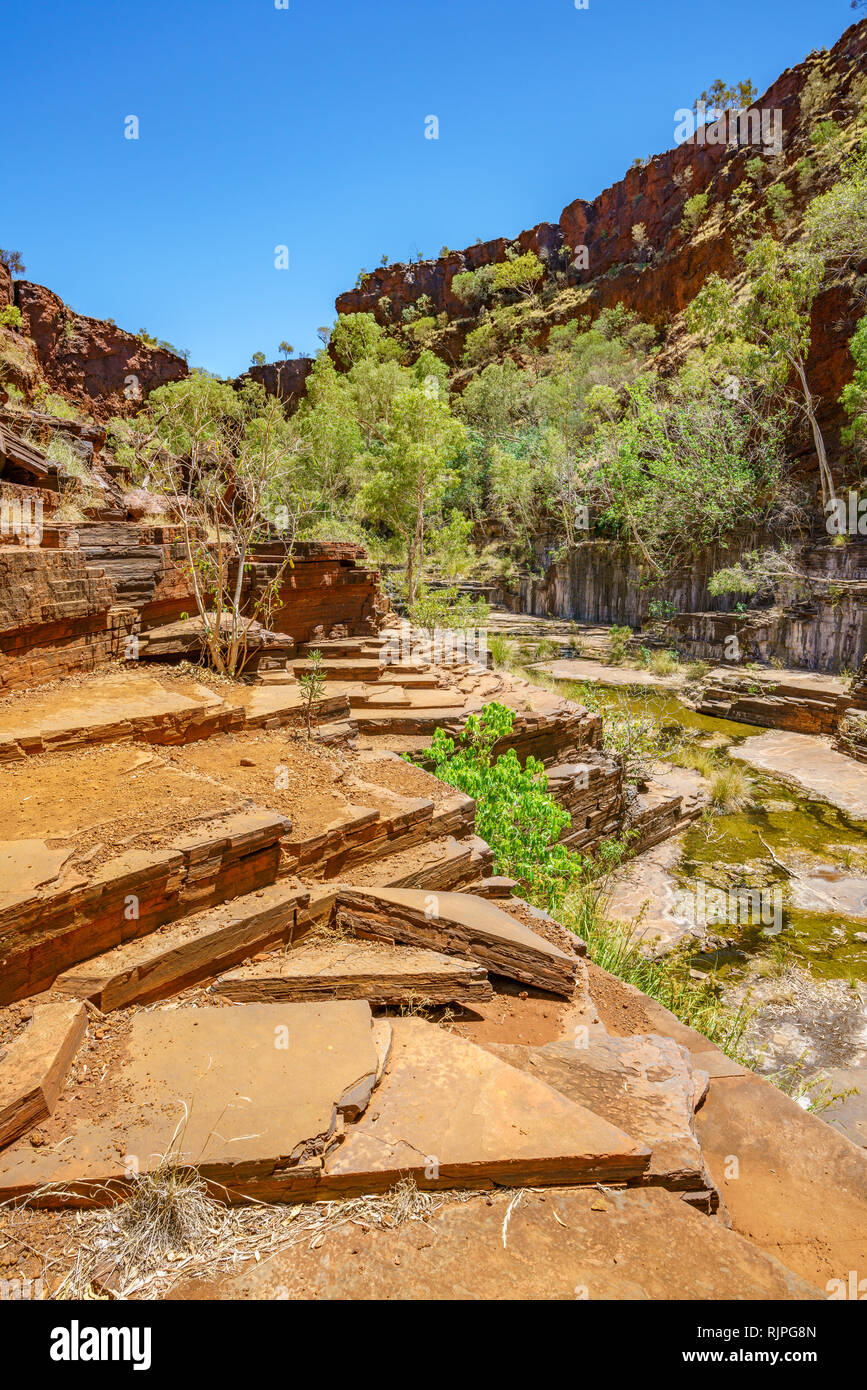 hiking over rocks in dales gorge, karijini national park, western ...