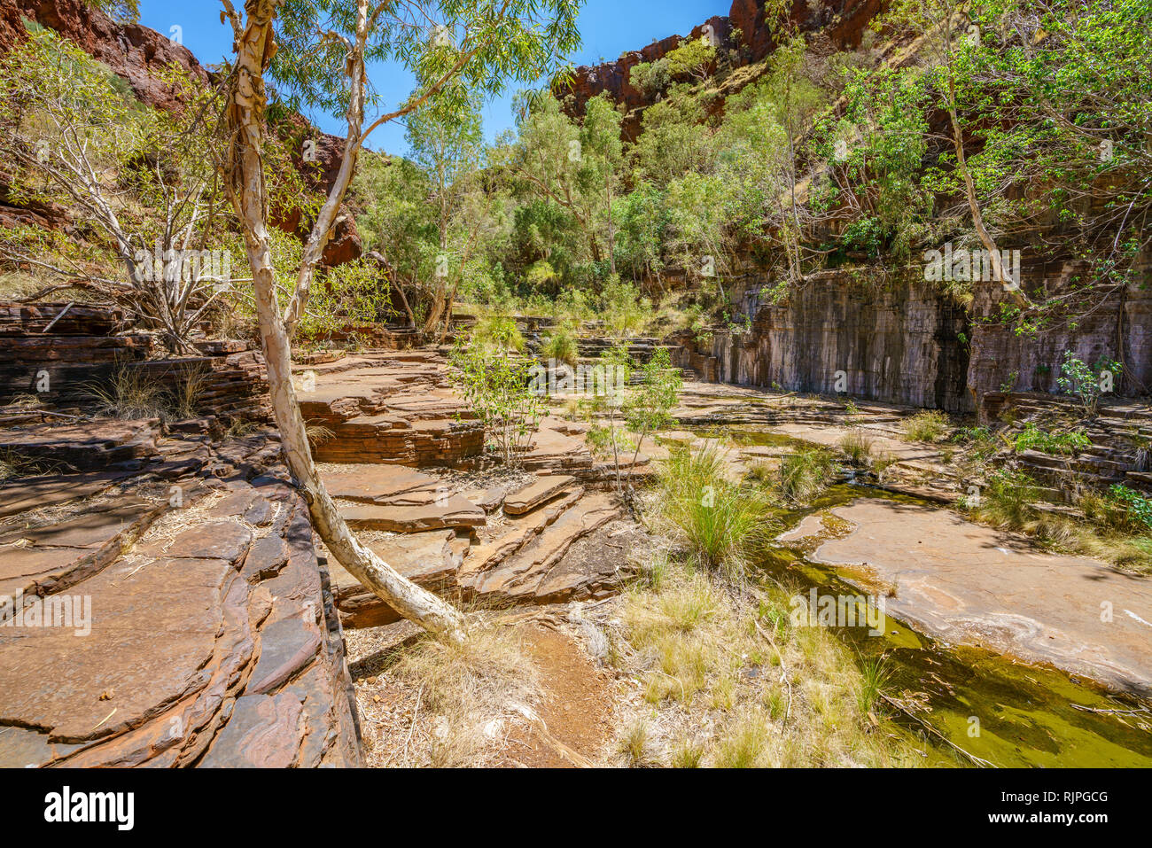 hiking over rocks in dales gorge, karijini national park, western ...