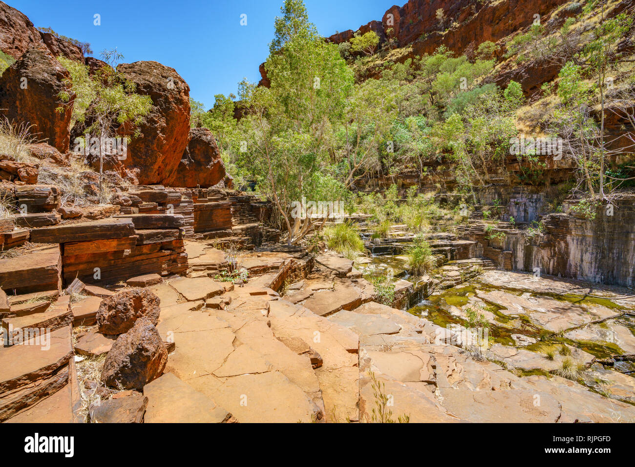 hiking over rocks in dales gorge, karijini national park, western ...