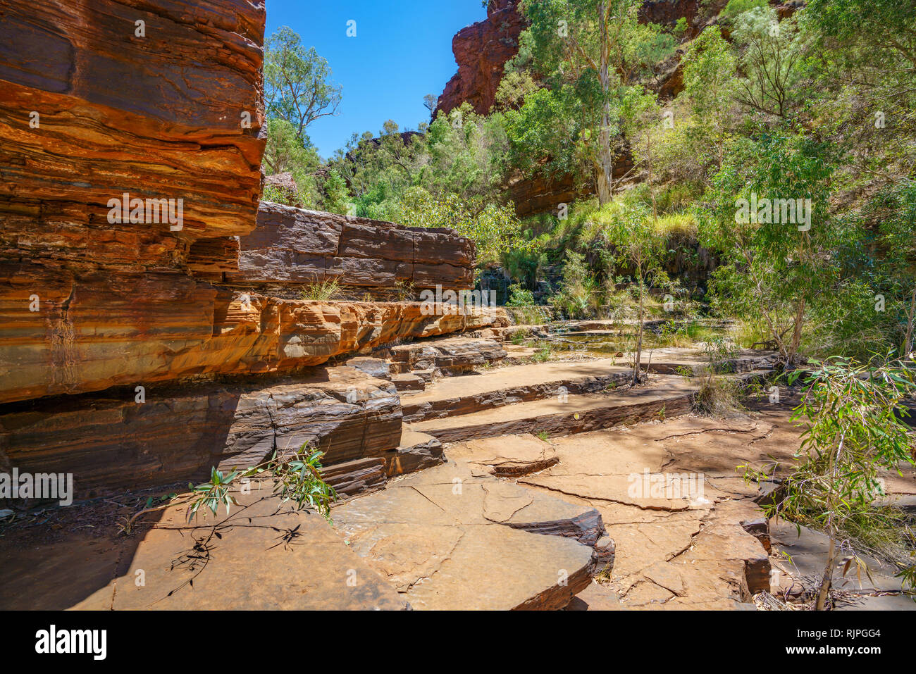 hiking over rocks in dales gorge, karijini national park, western ...