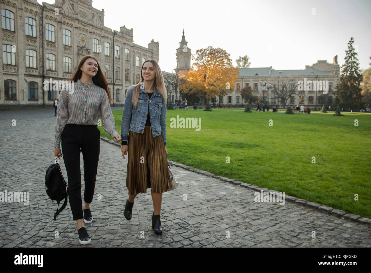 Two beautiful girls walk near the university Stock Photo - Alamy