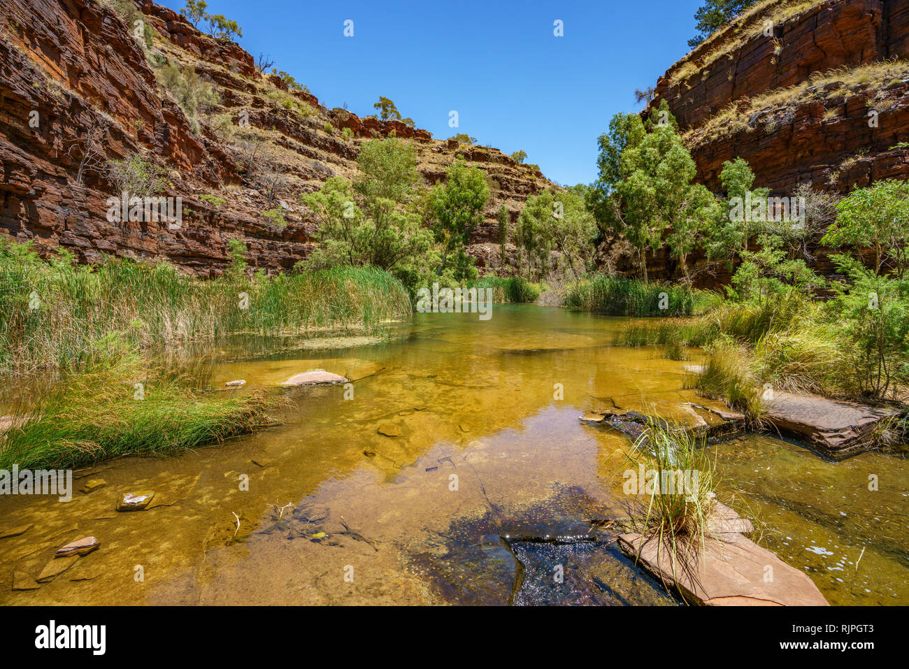 hiking over rocks in dales gorge, karijini national park, western ...