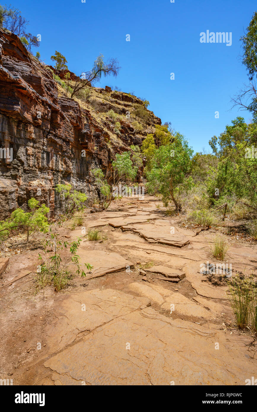 hiking over rocks in dales gorge, karijini national park, western ...