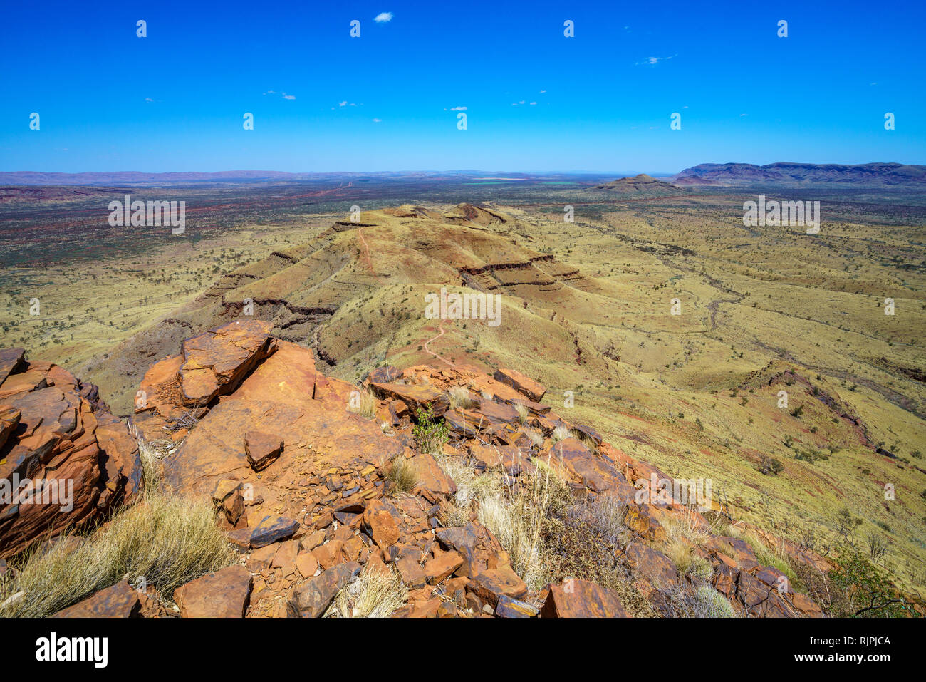 hiking on mount bruce in the desert of karijini national park, western ...
