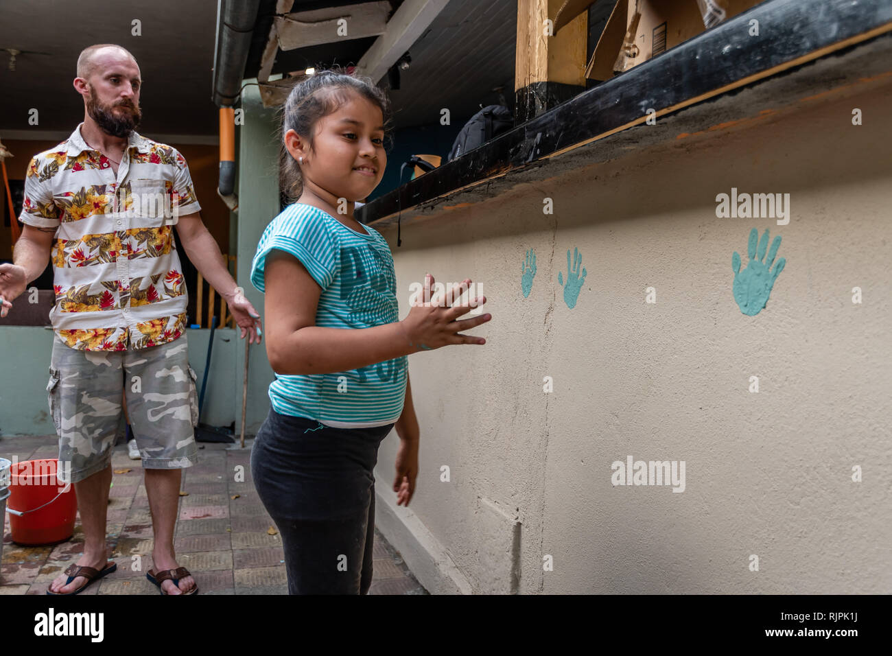 young latin girl making hand prints in Guatemala Stock Photo - Alamy