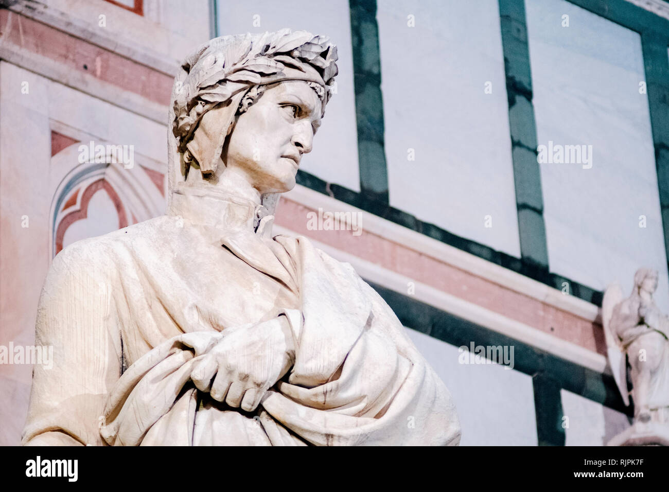 Dante Alighieri statue in Santa Croce square in Florence at night ...