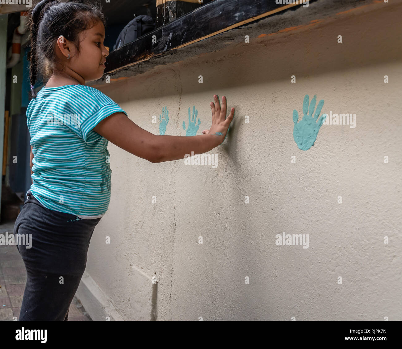 young latin girl making hand prints in Guatemala Stock Photo - Alamy