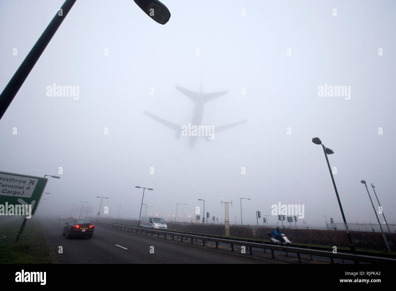 An aircraft lands at London Heathrow airport in heavy fog on March 13 ...