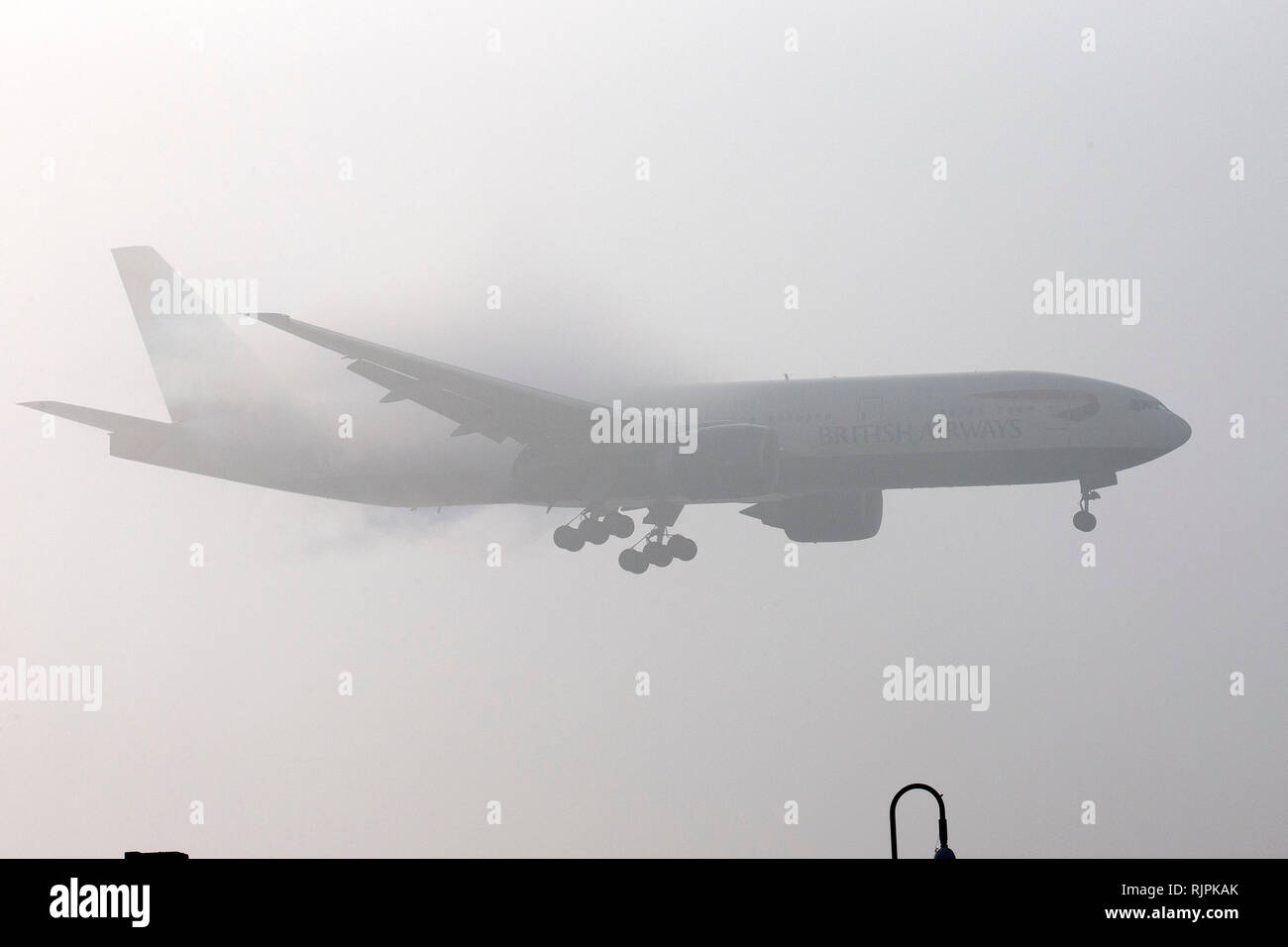 An aircraft lands at London Heathrow airport in heavy fog on March 13 ...