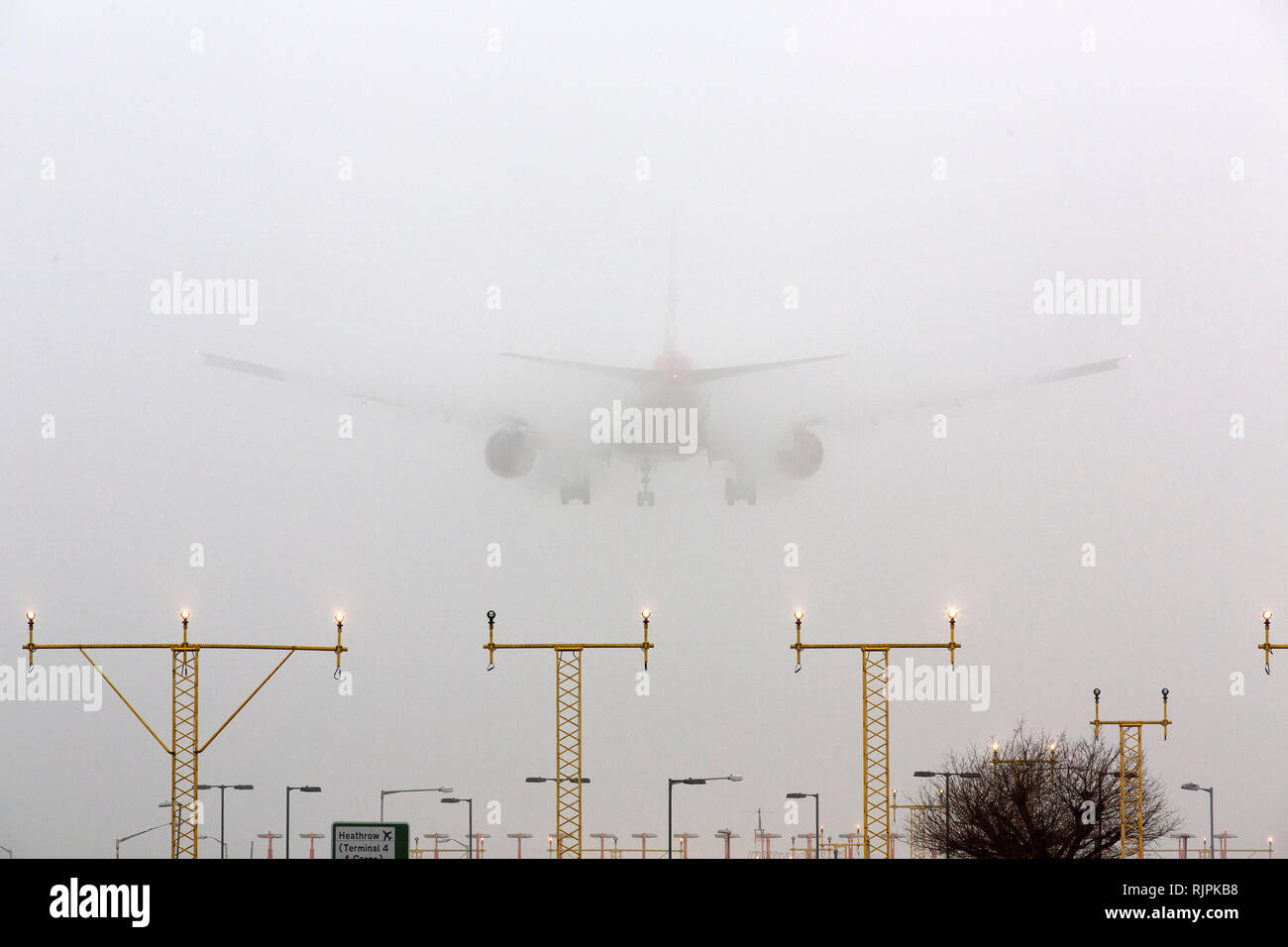 An aircraft lands at London Heathrow airport in heavy fog on March 13 ...