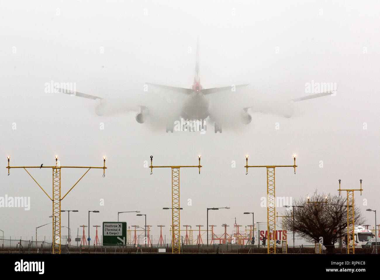 An aircraft lands at London Heathrow airport in heavy fog on March 13 ...